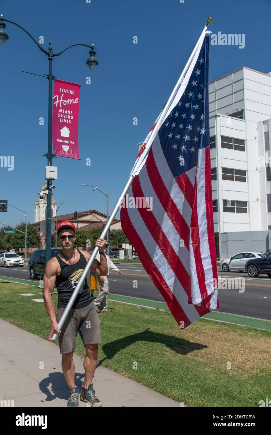 Beverly Hills, CA/USA - Aug 1, 2020: A patriot with an American flag at ...