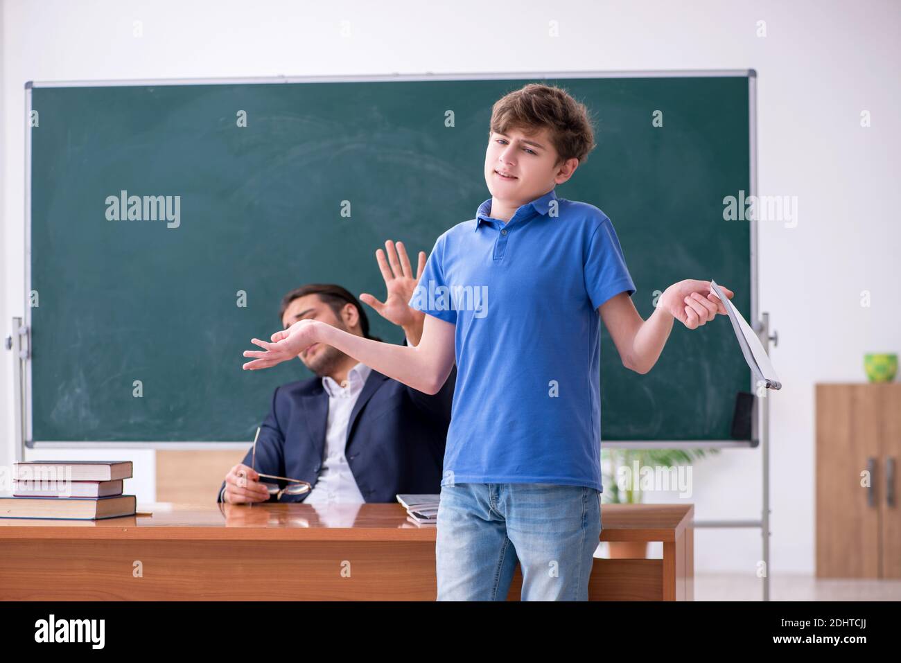 Male teacher and schoolboy in the classroom Stock Photo - Alamy