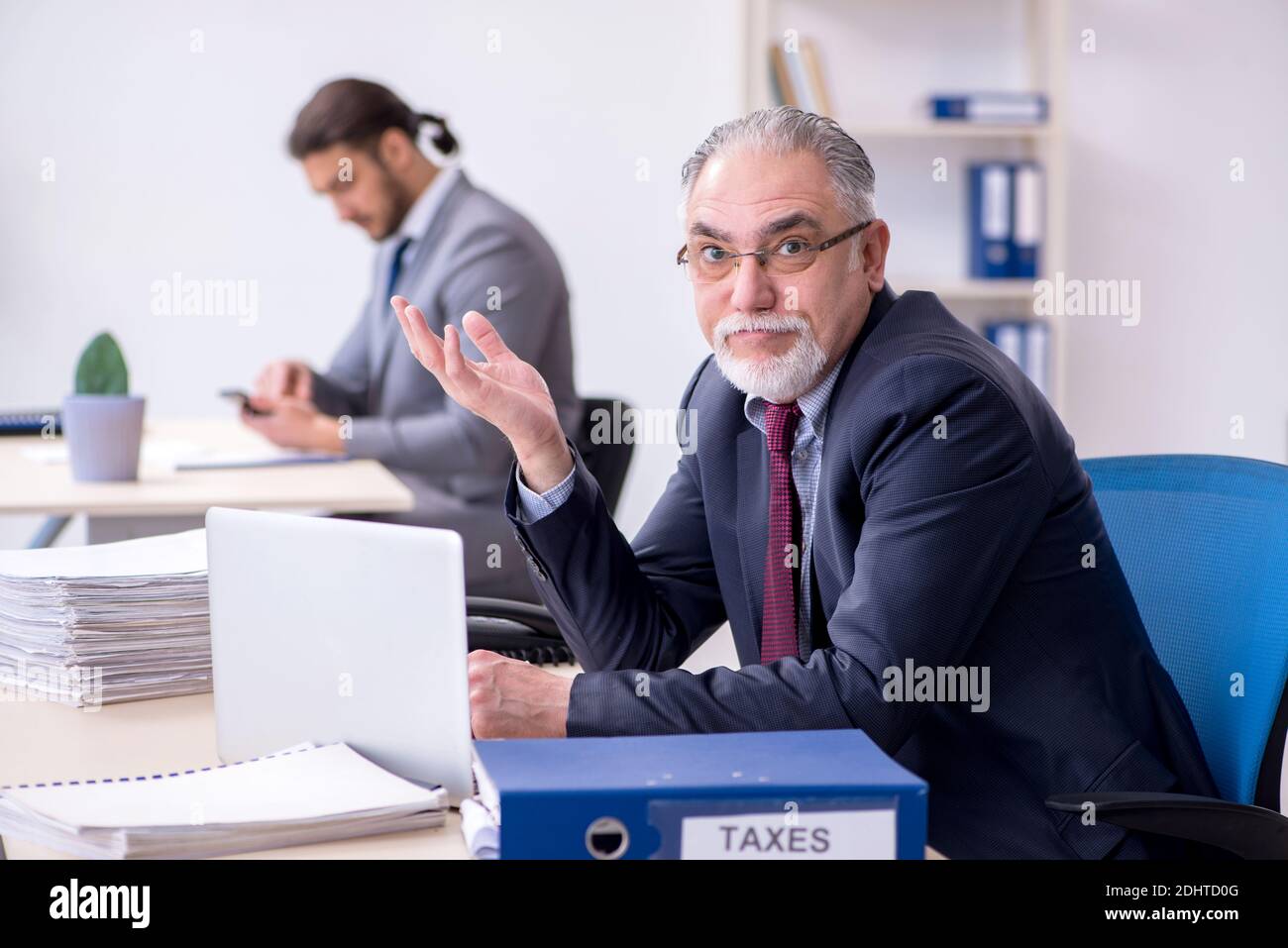 Old boss and his assistant working in the office Stock Photo - Alamy