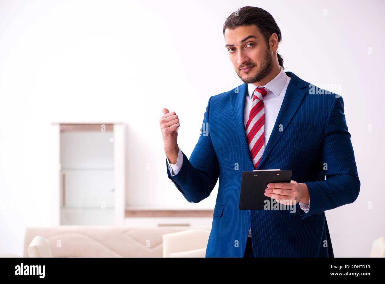 Young male realtor working indoors Stock Photo - Alamy
