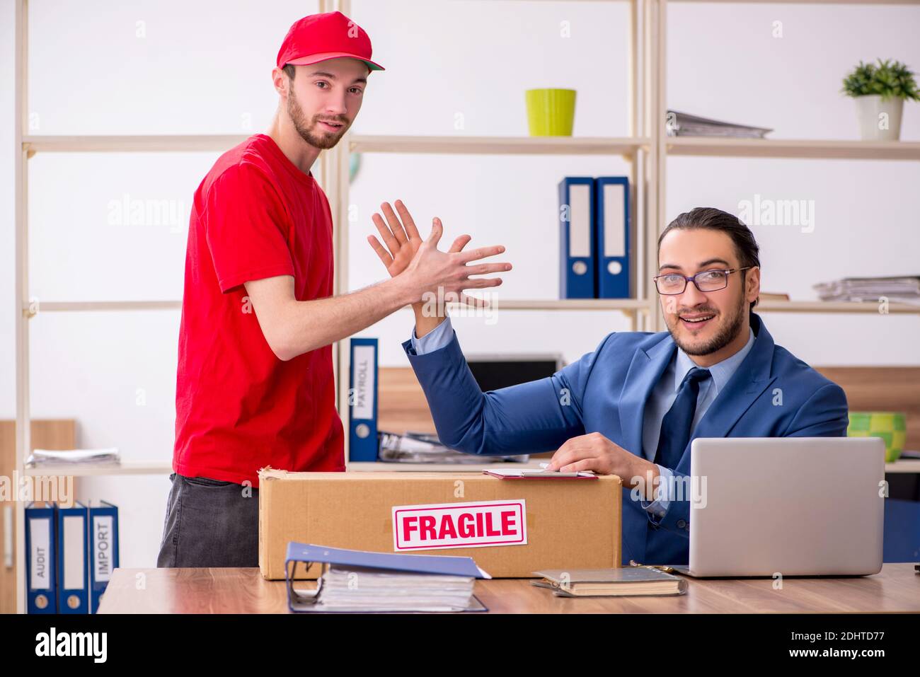 Man delivering parcel to the office Stock Photo - Alamy
