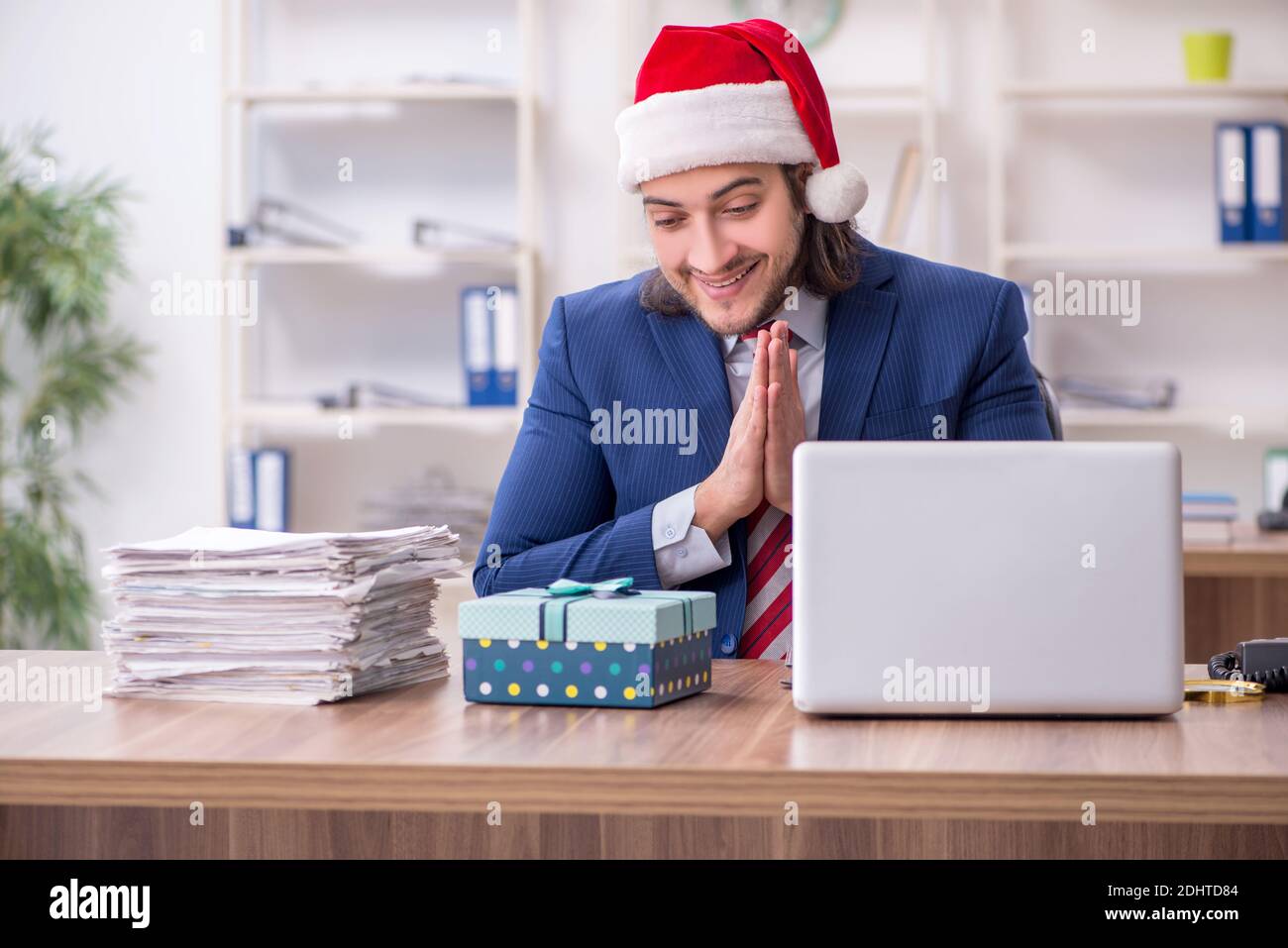 Young employee working in the office at Christmas Eve Stock Photo - Alamy