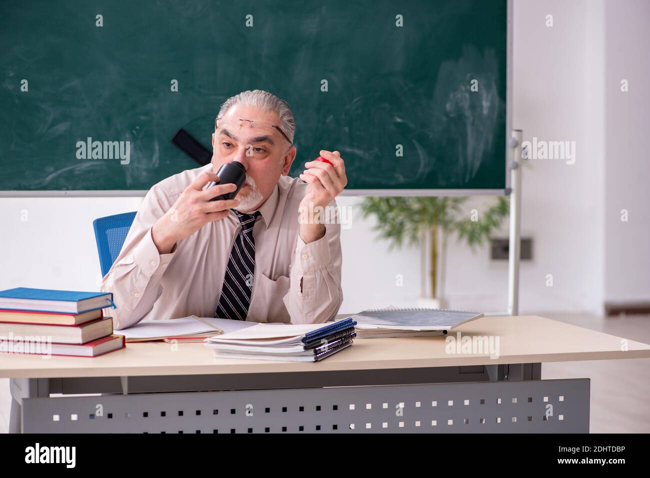 Old experienced teacher in the classroom Stock Photo - Alamy