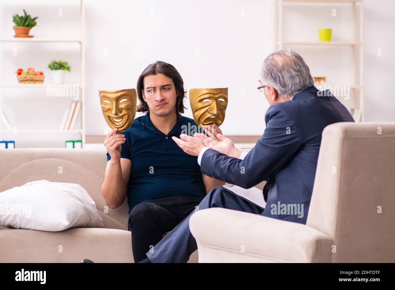 Man wearing masks during psychotherapy session Stock Photo - Alamy