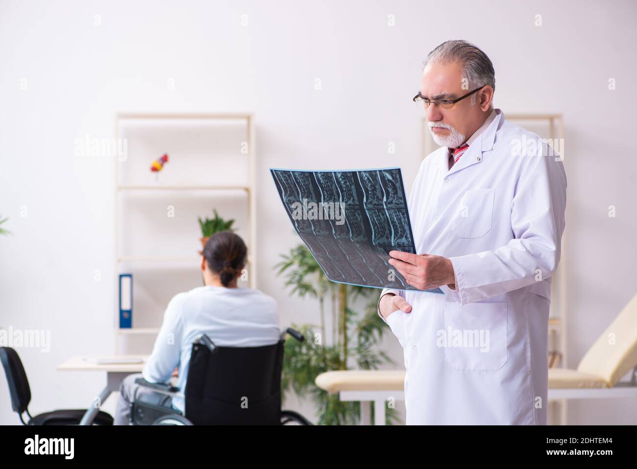 Man in wheel-chair and old doctor radiologist Stock Photo - Alamy