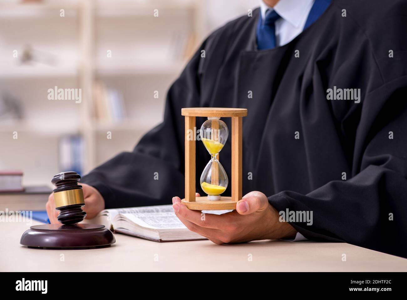 Young judge in time management concept Stock Photo - Alamy