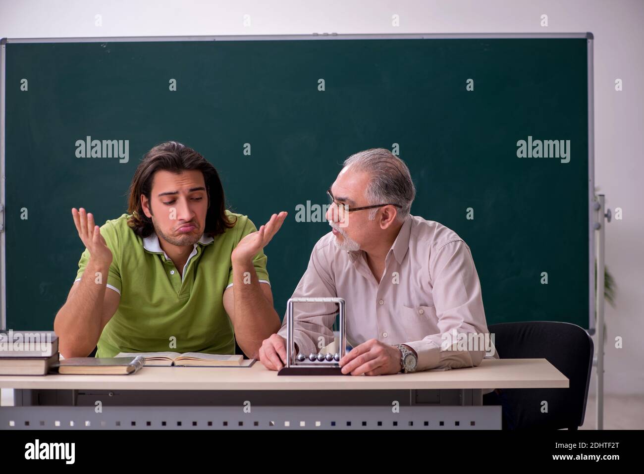 Old professor physicist and student in the classroom Stock Photo - Alamy