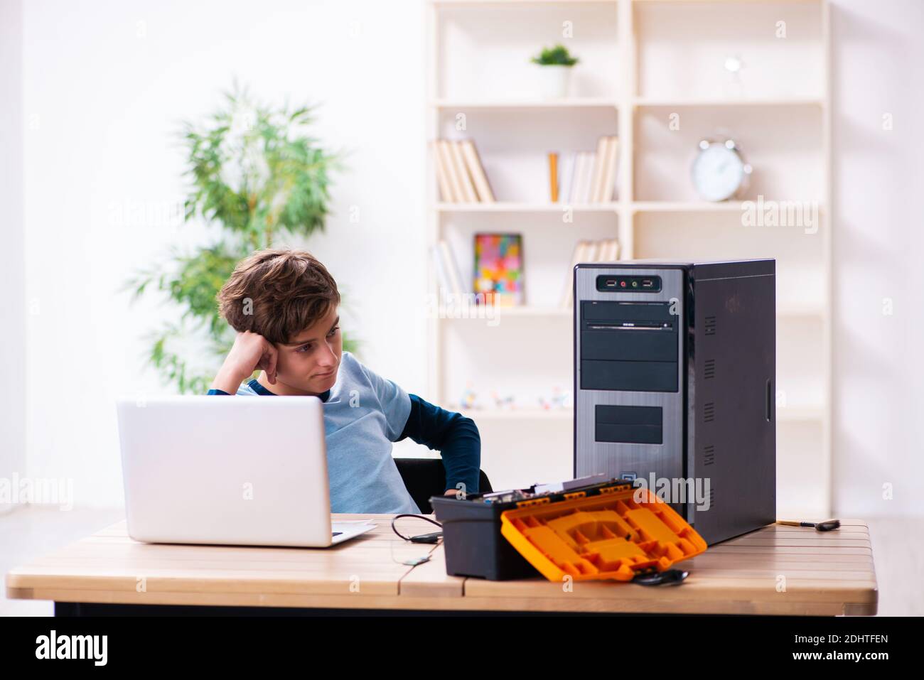 Teenager reparing computers at workshop Stock Photo - Alamy