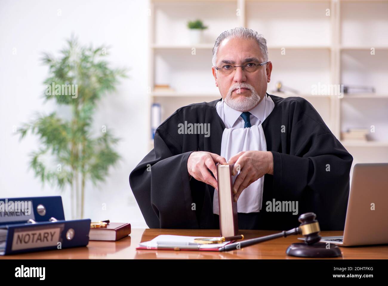 Old male judge working in the courthouse Stock Photo - Alamy