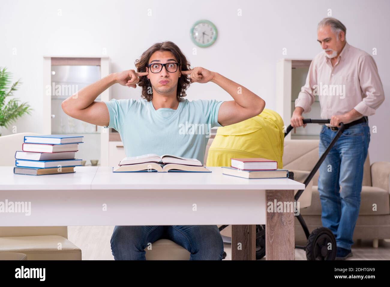 Old grandfather looking after newborn at home Stock Photo - Alamy