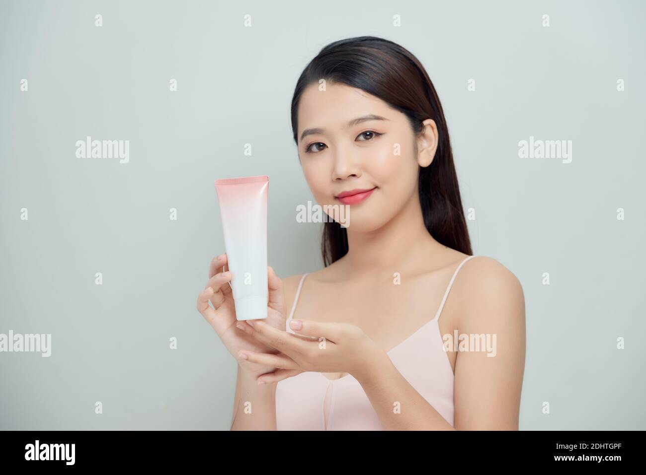 Beautiful Woman Face Portrait holding and presenting cream tube product ...