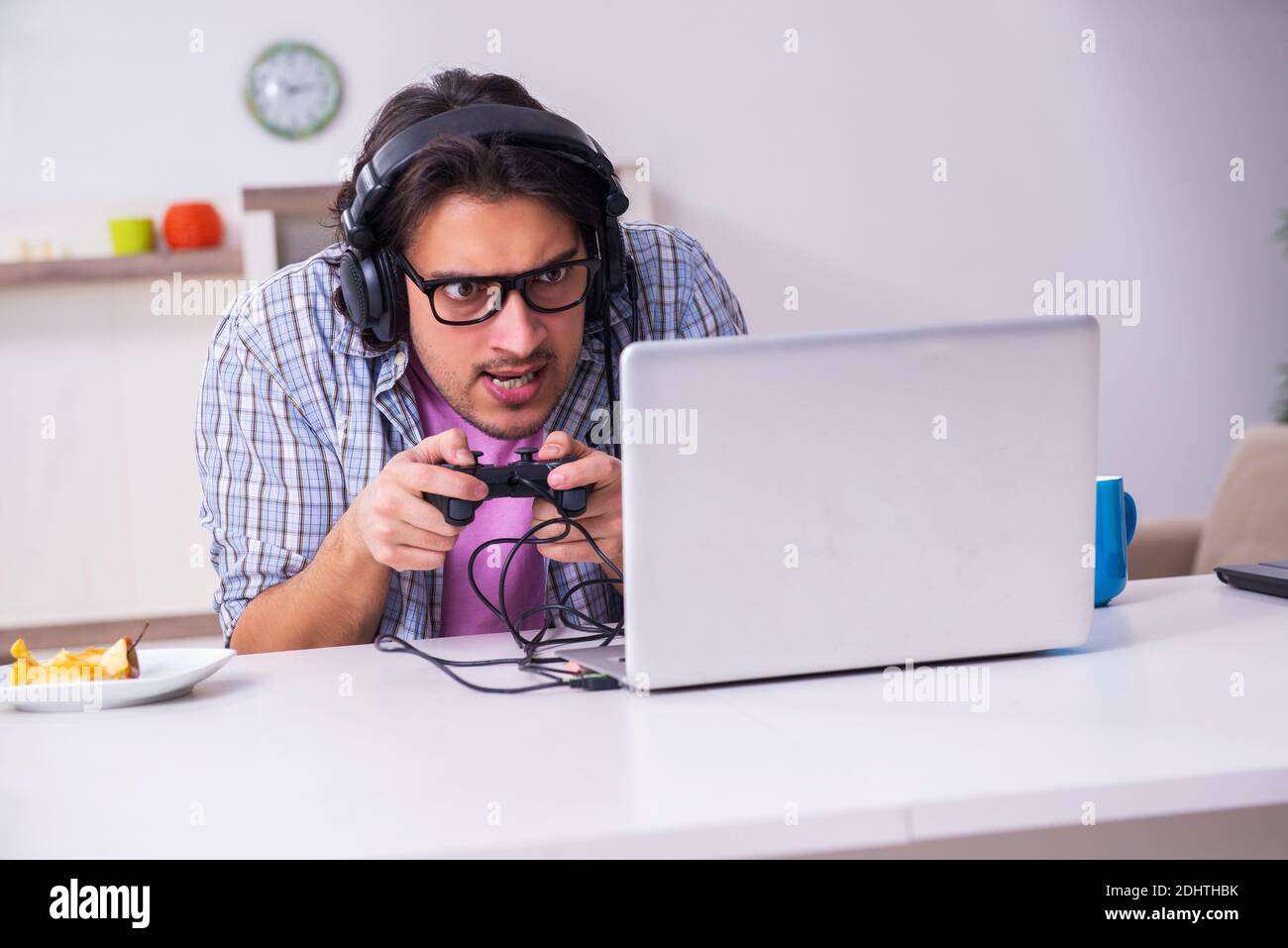 Male student playing computer games at home Stock Photo - Alamy