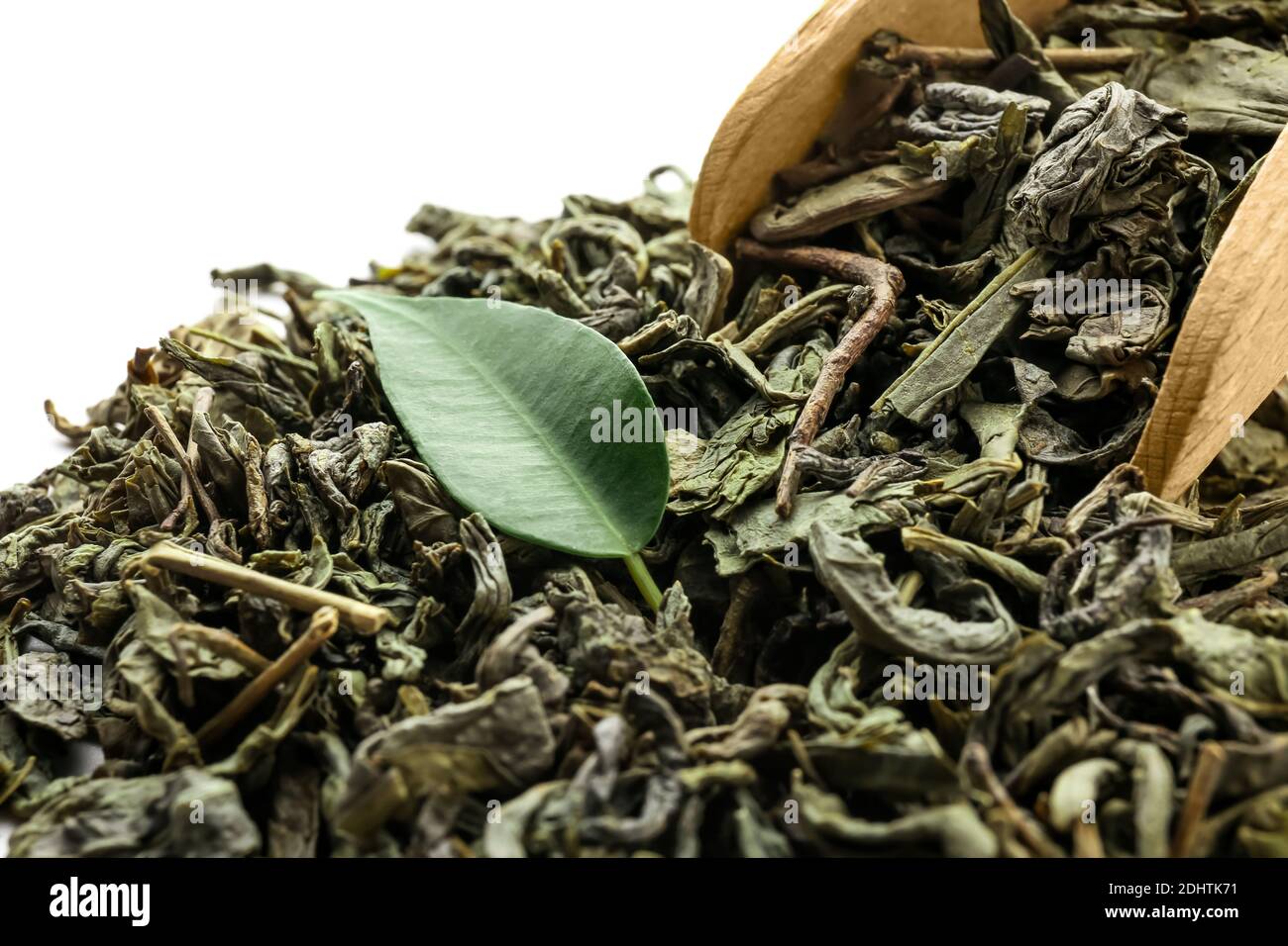 Pile of dry tea leaves and wooden scoop on white background Stock Photo ...