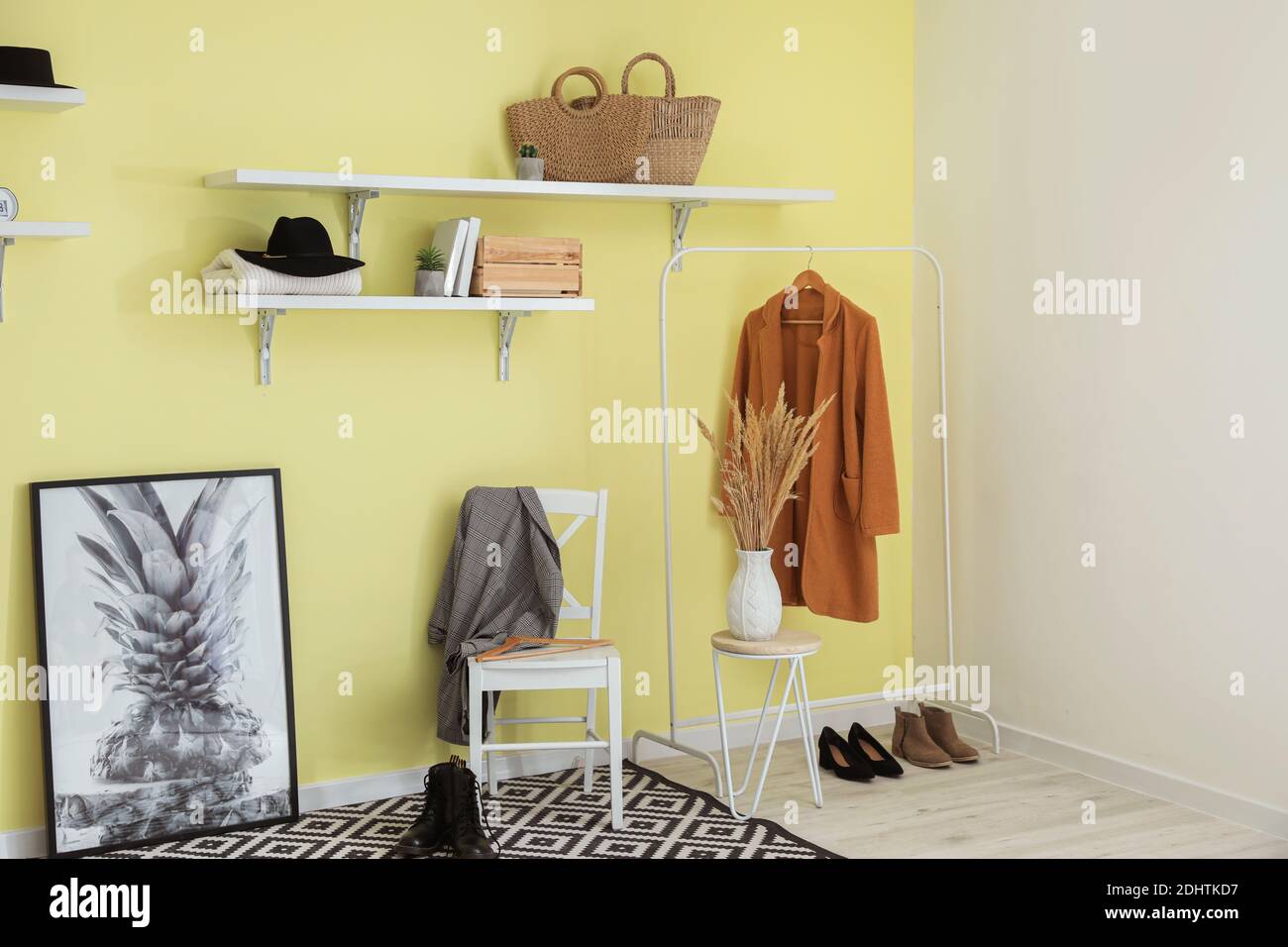 Stylish interior of modern hallway with rack Stock Photo - Alamy