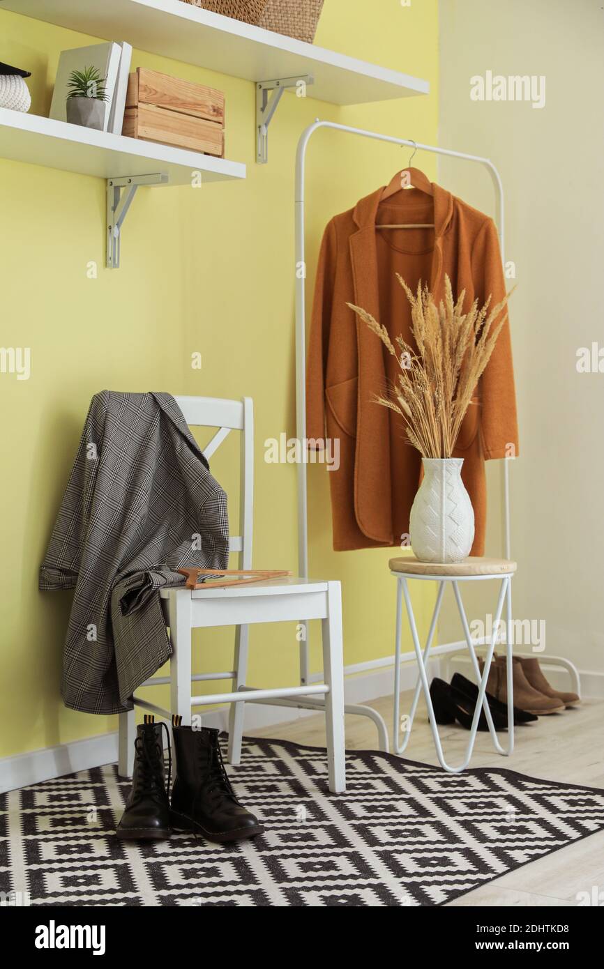Stylish interior of modern hallway with rack Stock Photo - Alamy