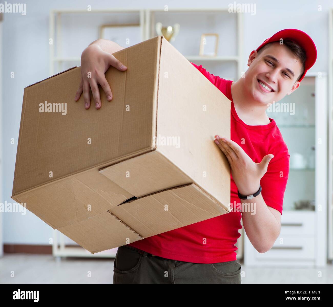 The post man delivering a parcel package Stock Photo - Alamy