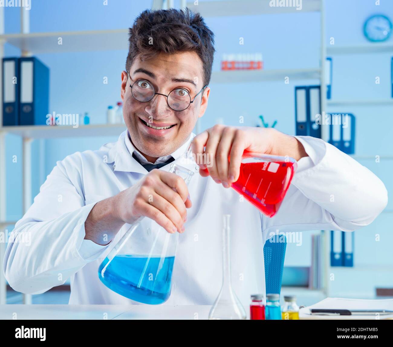 The funny mad chemist working in a laboratory Stock Photo - Alamy