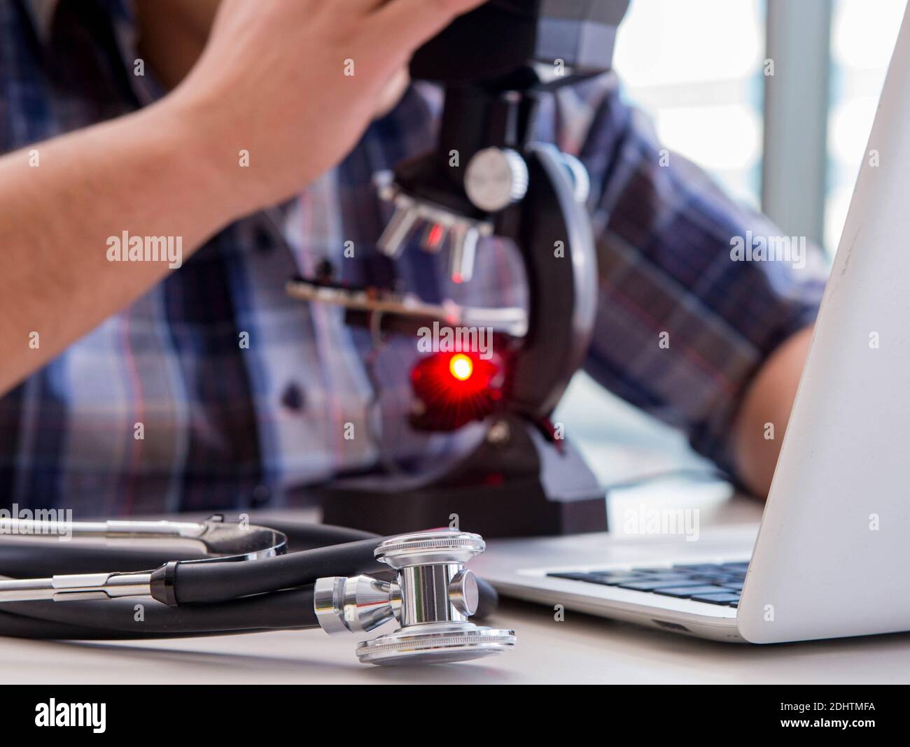 The high precision engineering with man working with microscope Stock ...