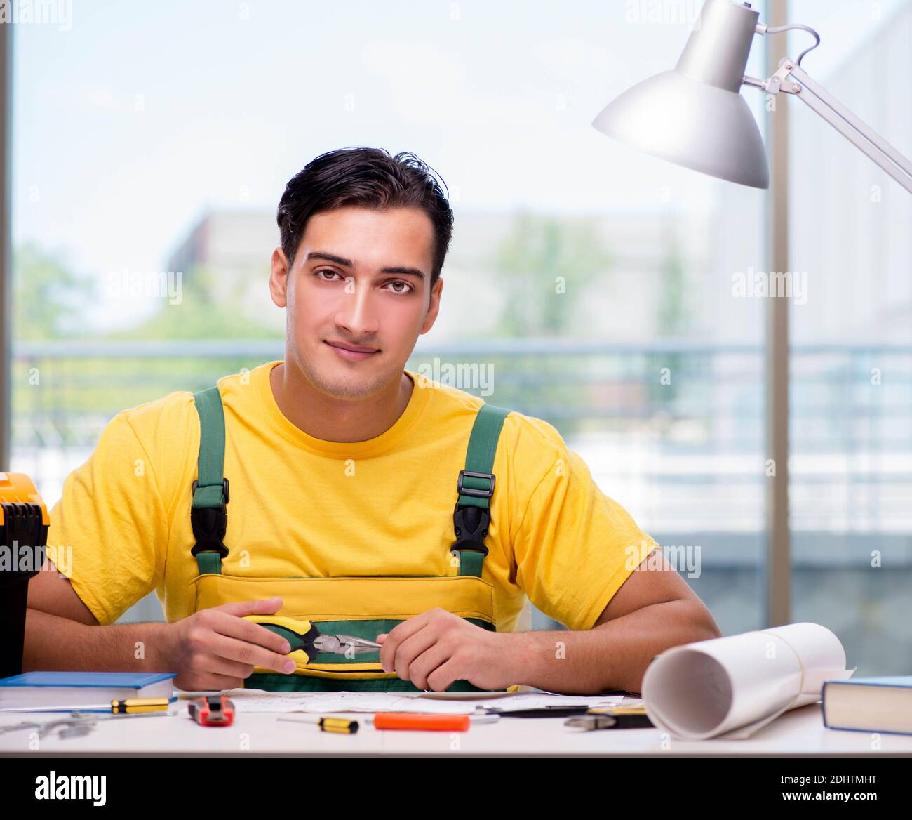 The construction worker sitting at the desk Stock Photo - Alamy
