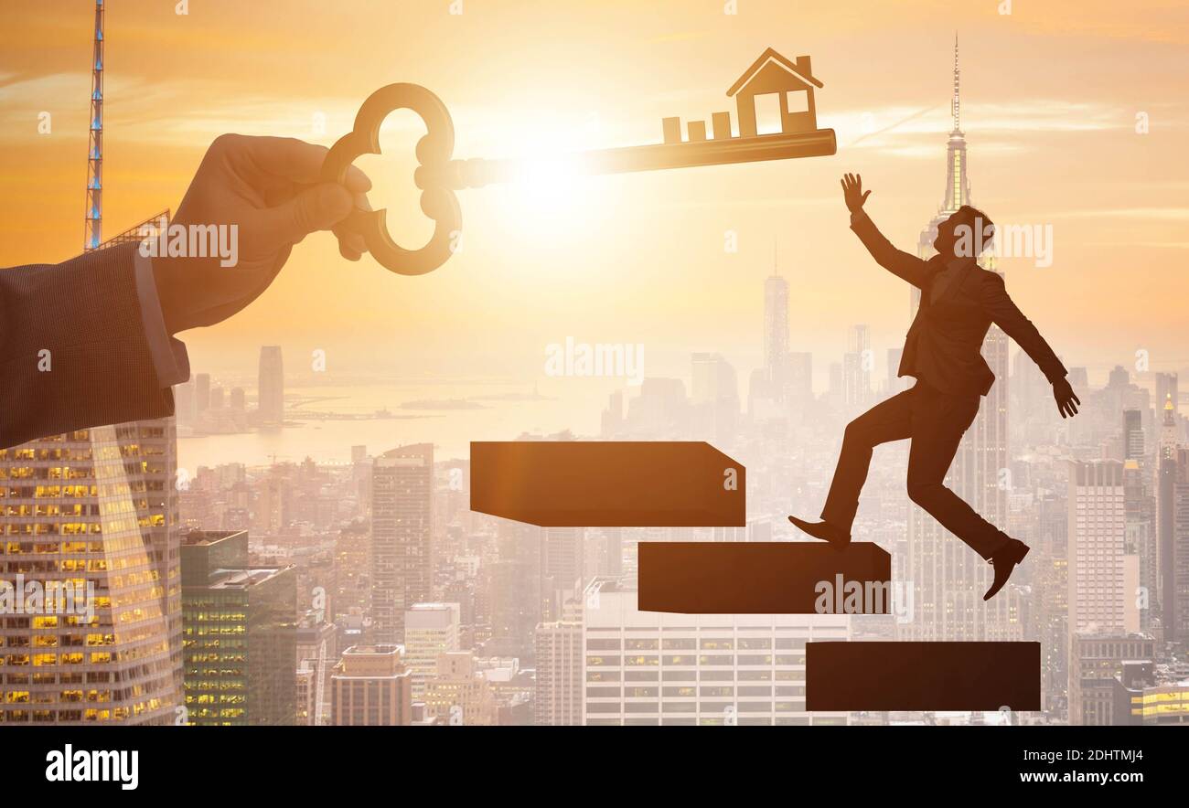 The businessman holding key in real estate concept Stock Photo - Alamy