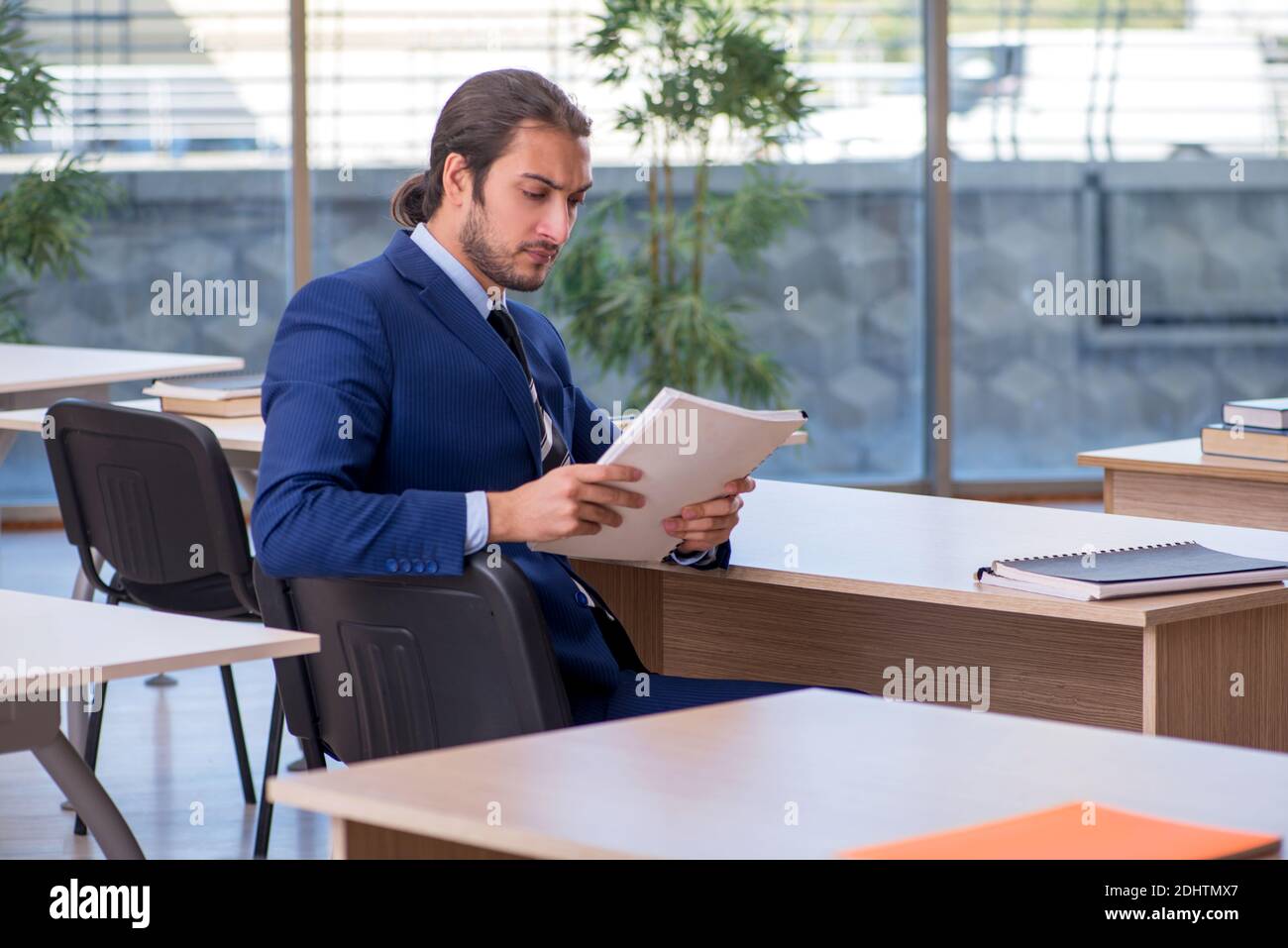 Young teacher in suit in the classroom Stock Photo - Alamy