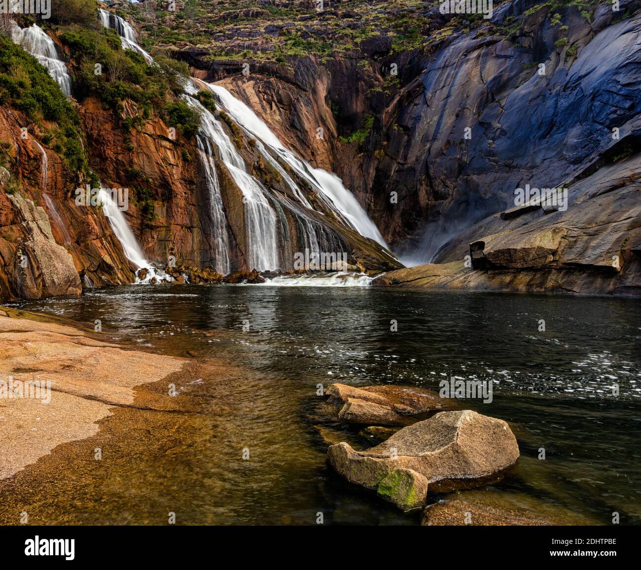 A beautiful waterfall in Ezaro cascading directly into the ocean Stock ...