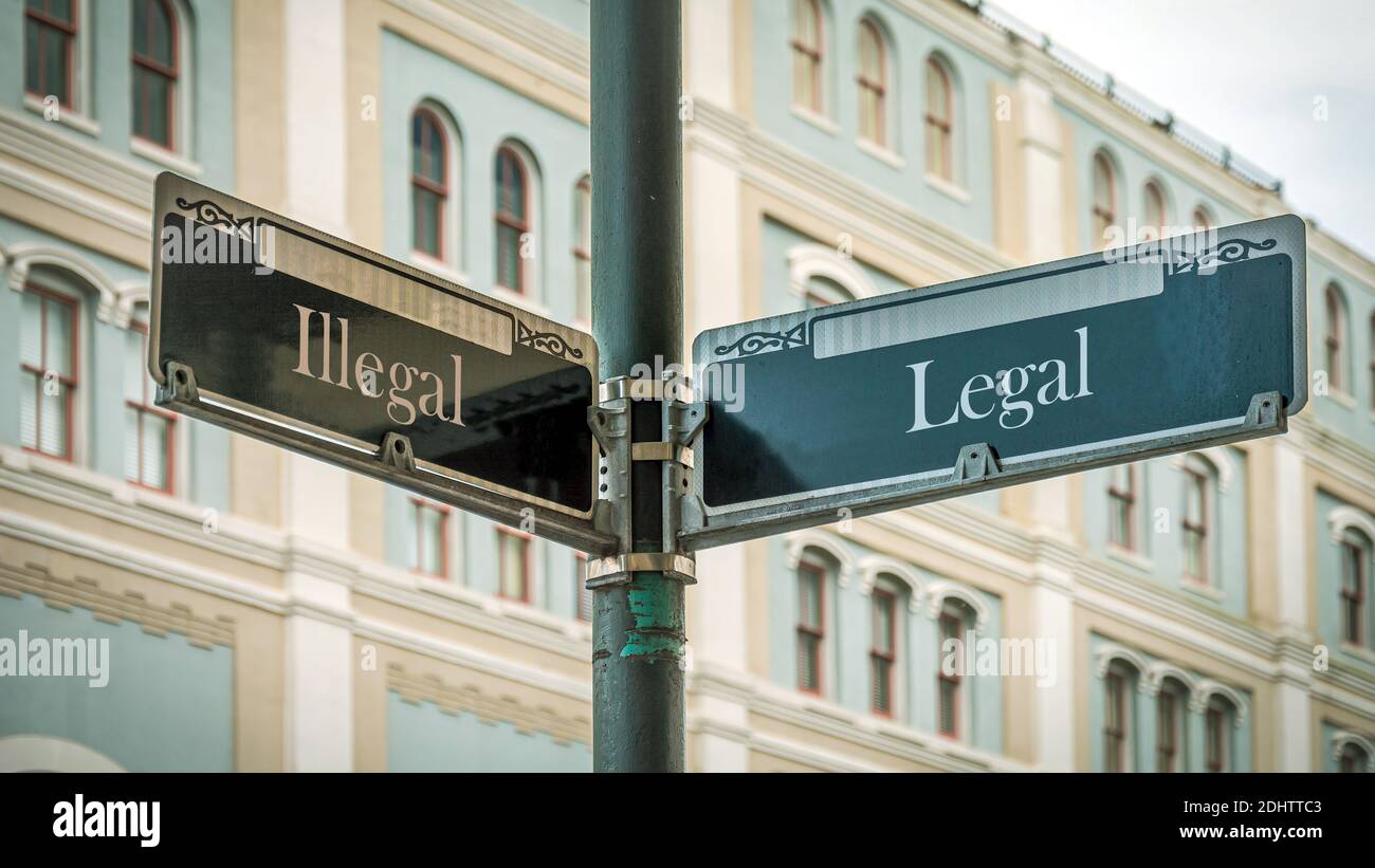 Street Sign the Direction Way to Legal versus Illegal Stock Photo - Alamy