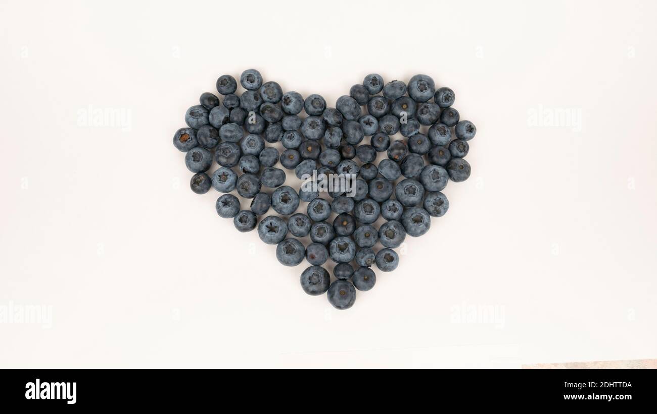 Raw blueberry heart shape on white background. Vegetarian food, blue ...