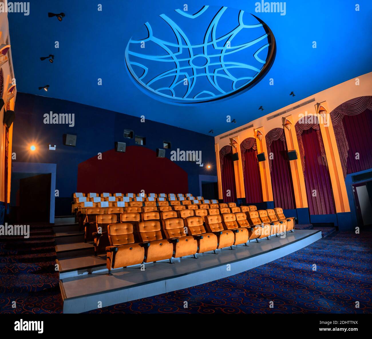 Large cinema theater interior with seat rows for audience to sit in ...