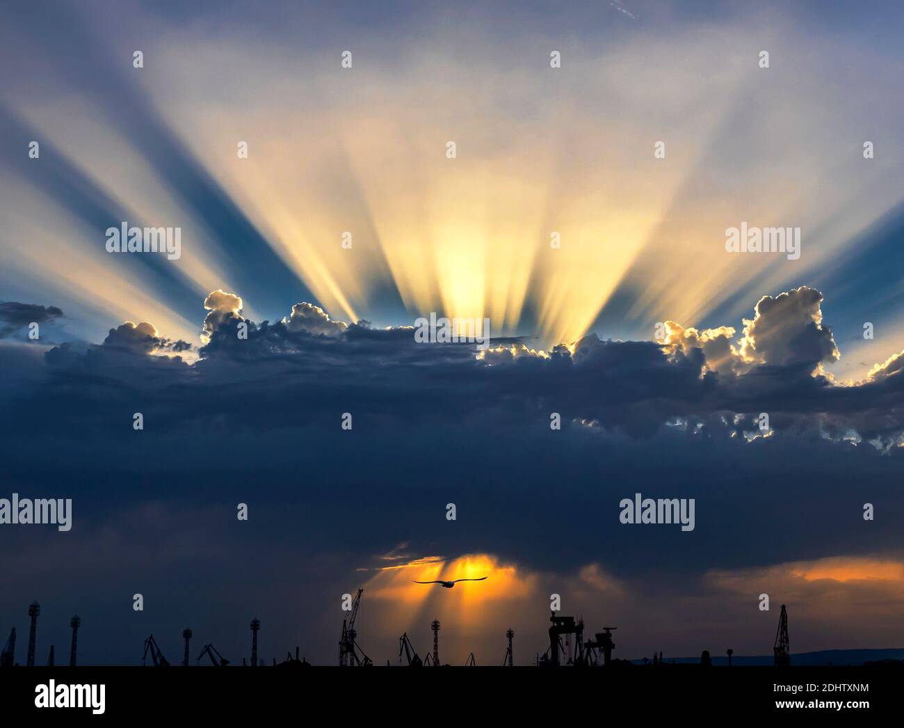 Colorful sunbeam behind clouds and over Cranes Stock Photo - Alamy