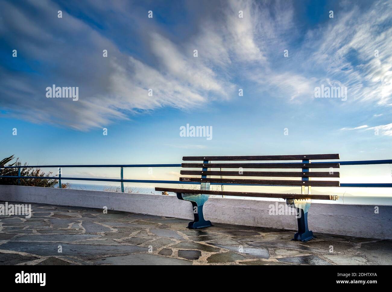 cloudscape and bench with view in Rafina city, Greece Stock Photo - Alamy