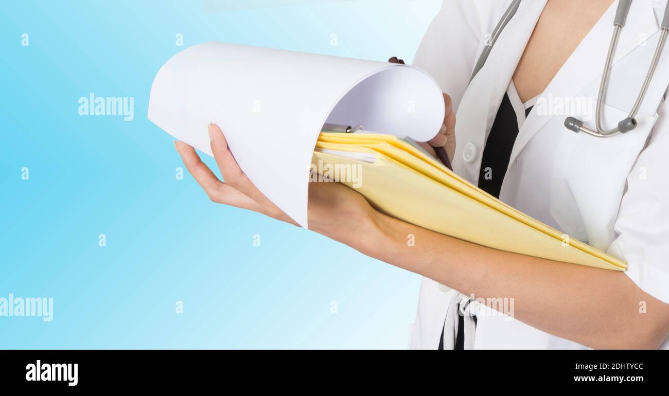 Half body of female doctor, no face, working on medical notes by hand ...