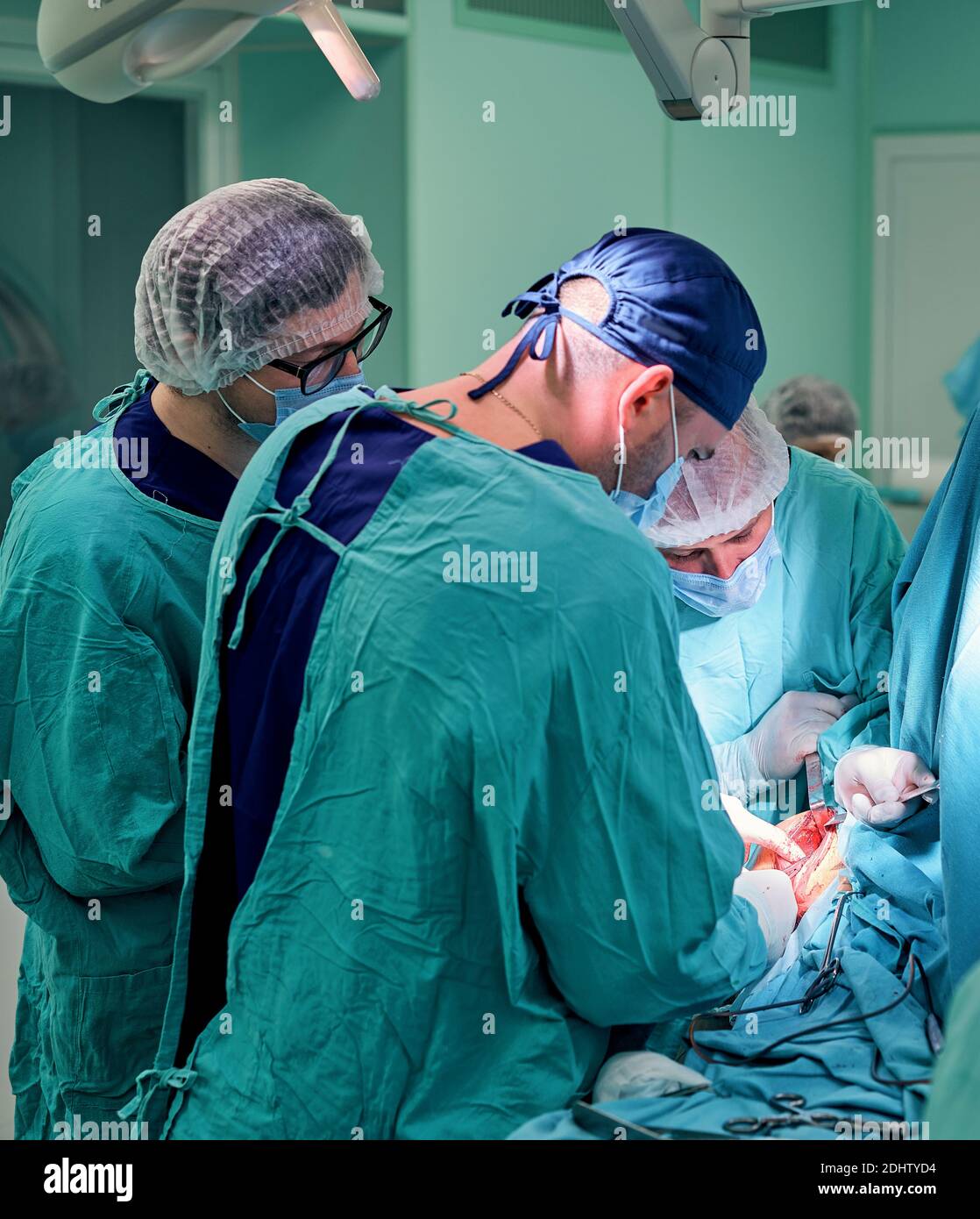 Physicians in Surgery looking down at patient Stock Photo - Alamy