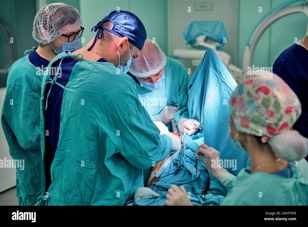 Physicians in Surgery looking down at patient Stock Photo - Alamy