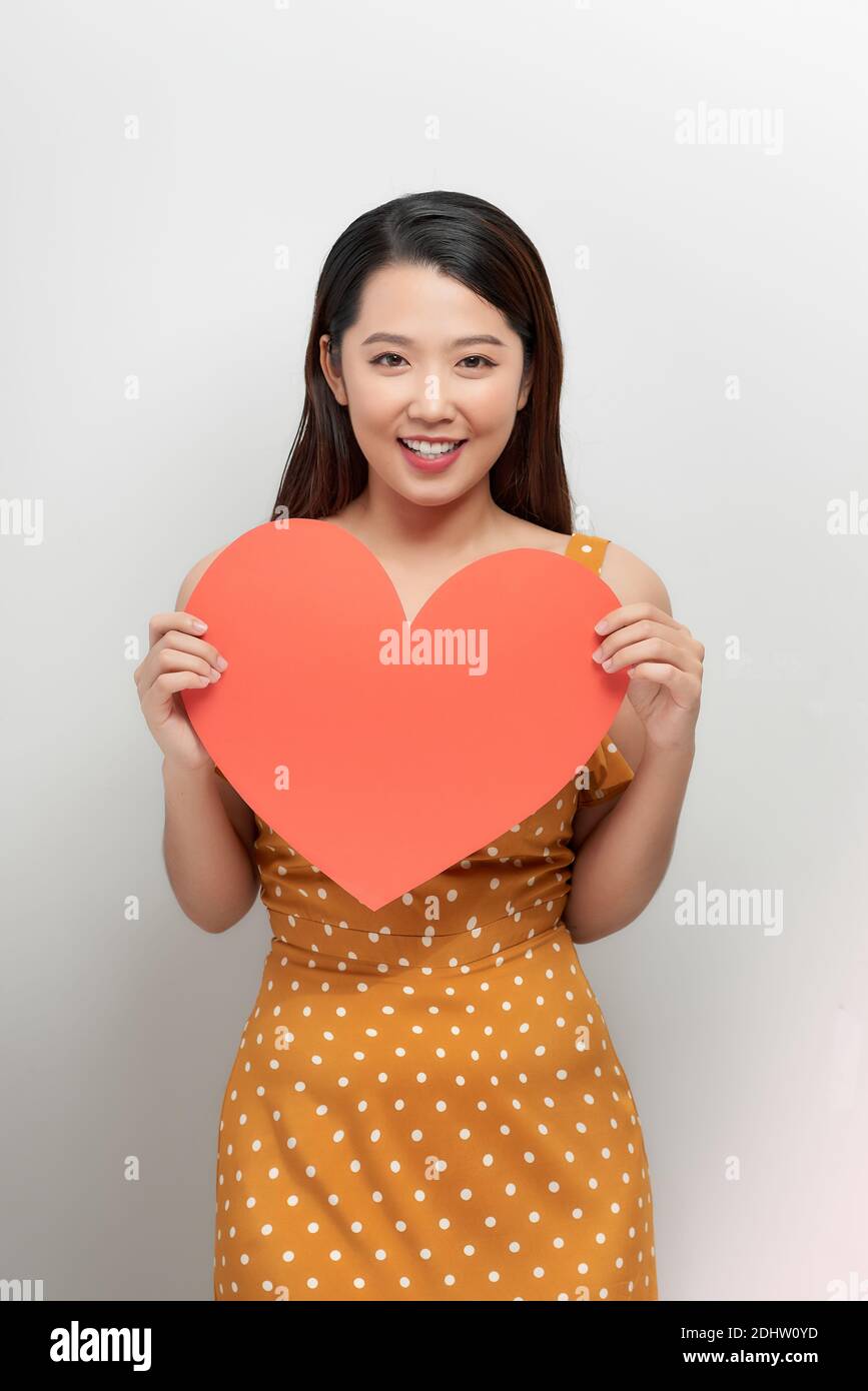 Photo of pretty lady hold hands hugging red paper heart affectionate ...