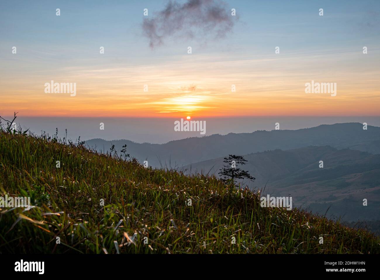 Landscape sunrise on the mountain with field and grass meadow beautiful ...