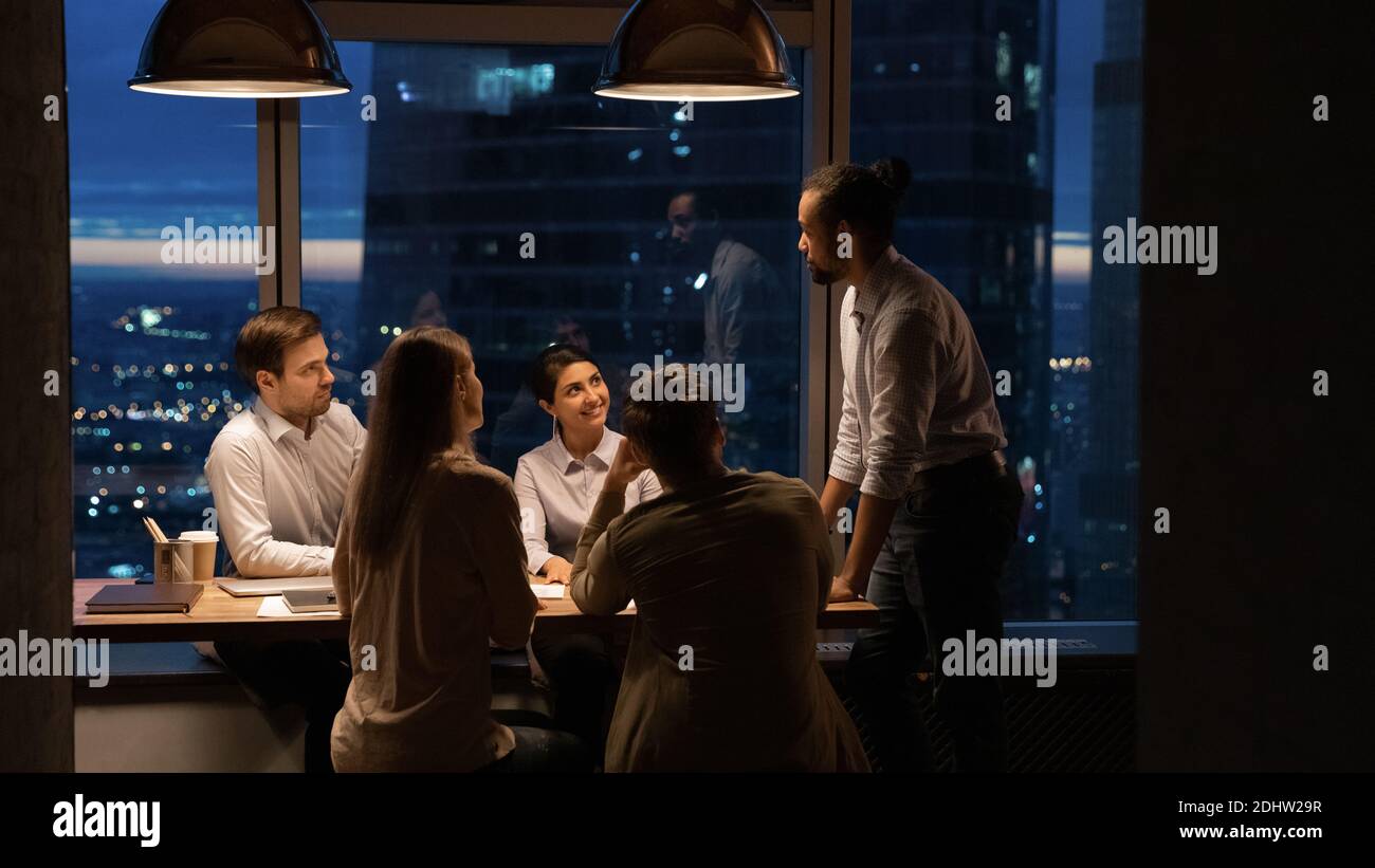 Banner view of diverse employee work late hours Stock Photo - Alamy