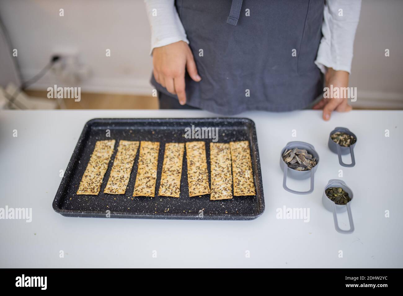 Black tray of Swedish crispbread on a white table Stock Photo - Alamy