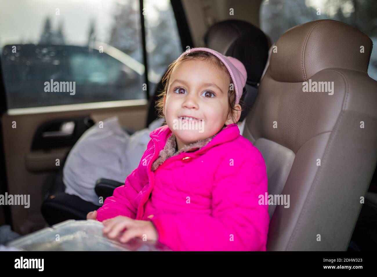 Happy and adorable little girl sitting inside a car Stock Photo - Alamy