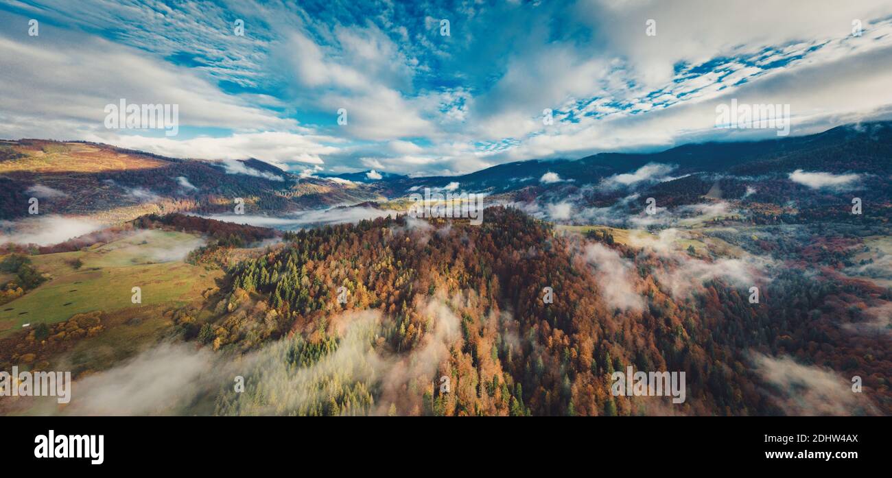 Autumn flight through blue sky in Carpatian autumn mountains, Aerial ...