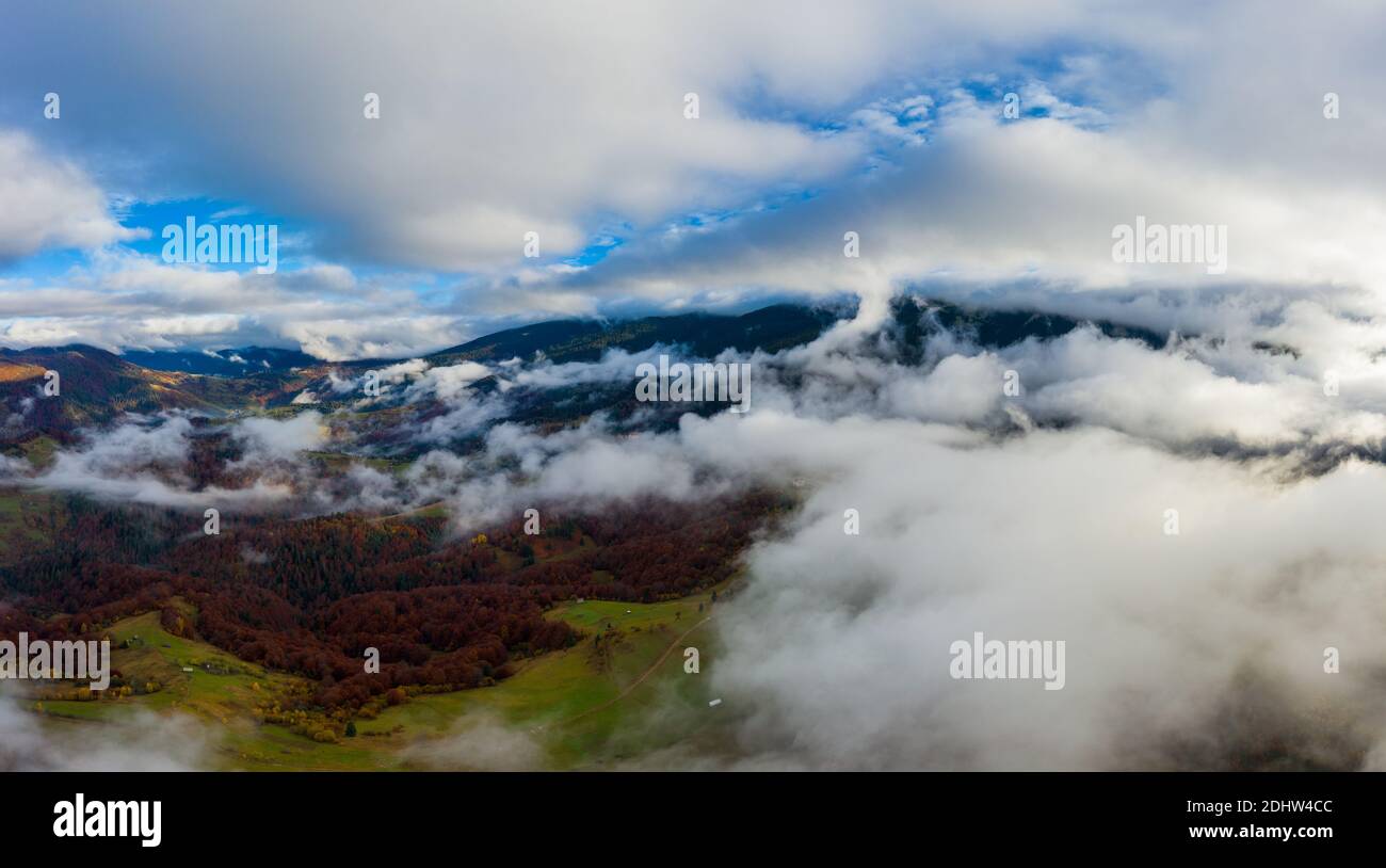 Autumn flight through blue sky in Carpatian autumn mountains, Aerial ...