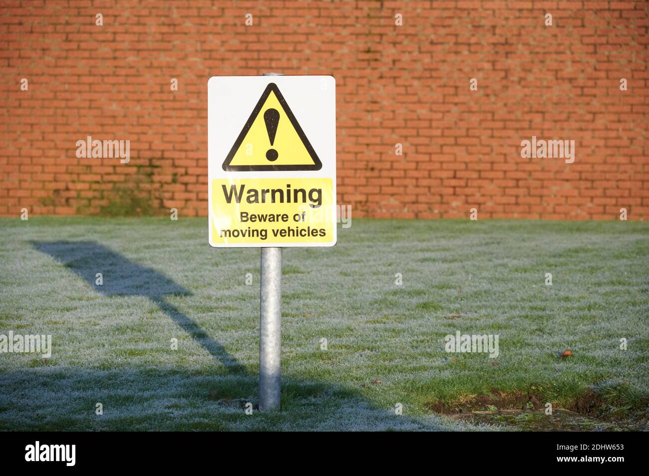 Danger of moving vehicles sign outside of factory warehouse Stock Photo ...