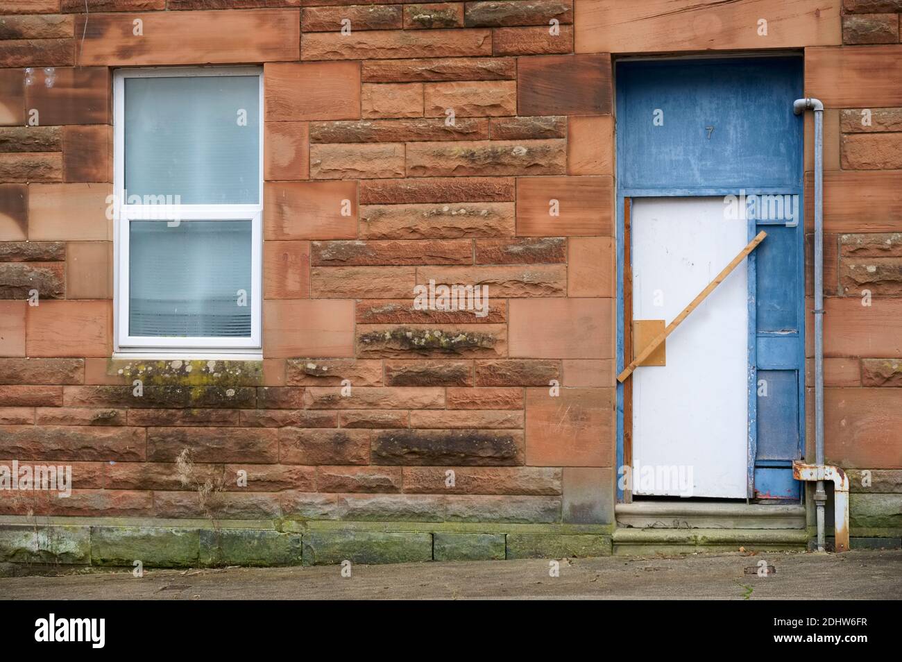 Derelict council house in poor housing estate slum with many social ...