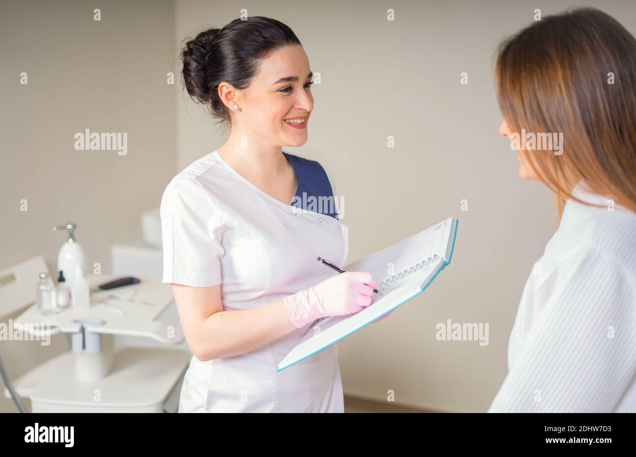 smiling Female Patient And Doctor Have Consultation In medical clinic ...