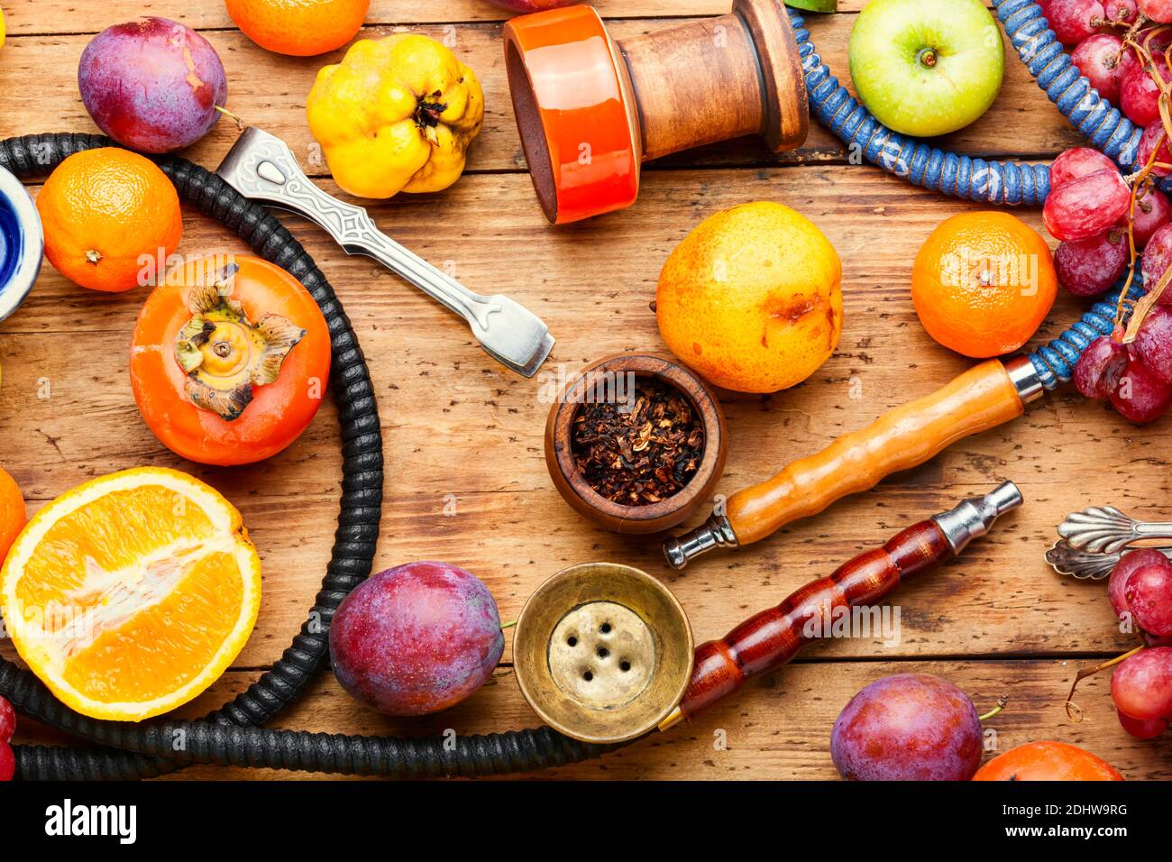 Smoking hookah with fresh fruit aroma.Tobacco fruit shisha.Making ...