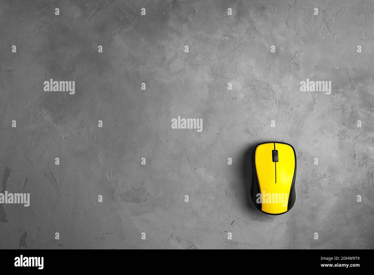 bright yellow computer mouse on a gray concrete background. Ultimate ...