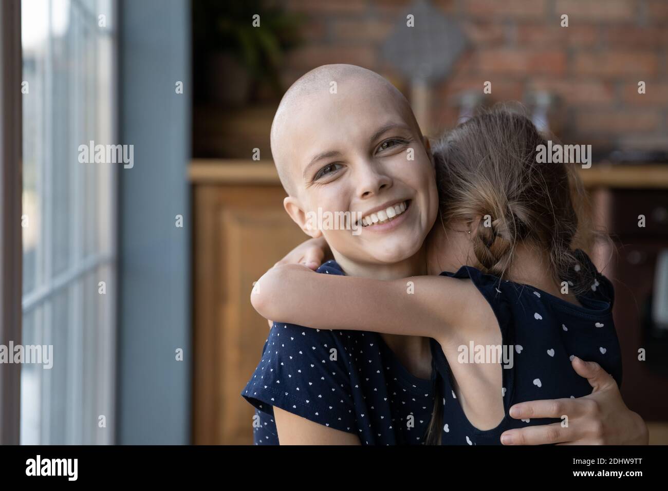 Head shot portrait smiling sick mother hugging little daughter Stock Photo - Alamy