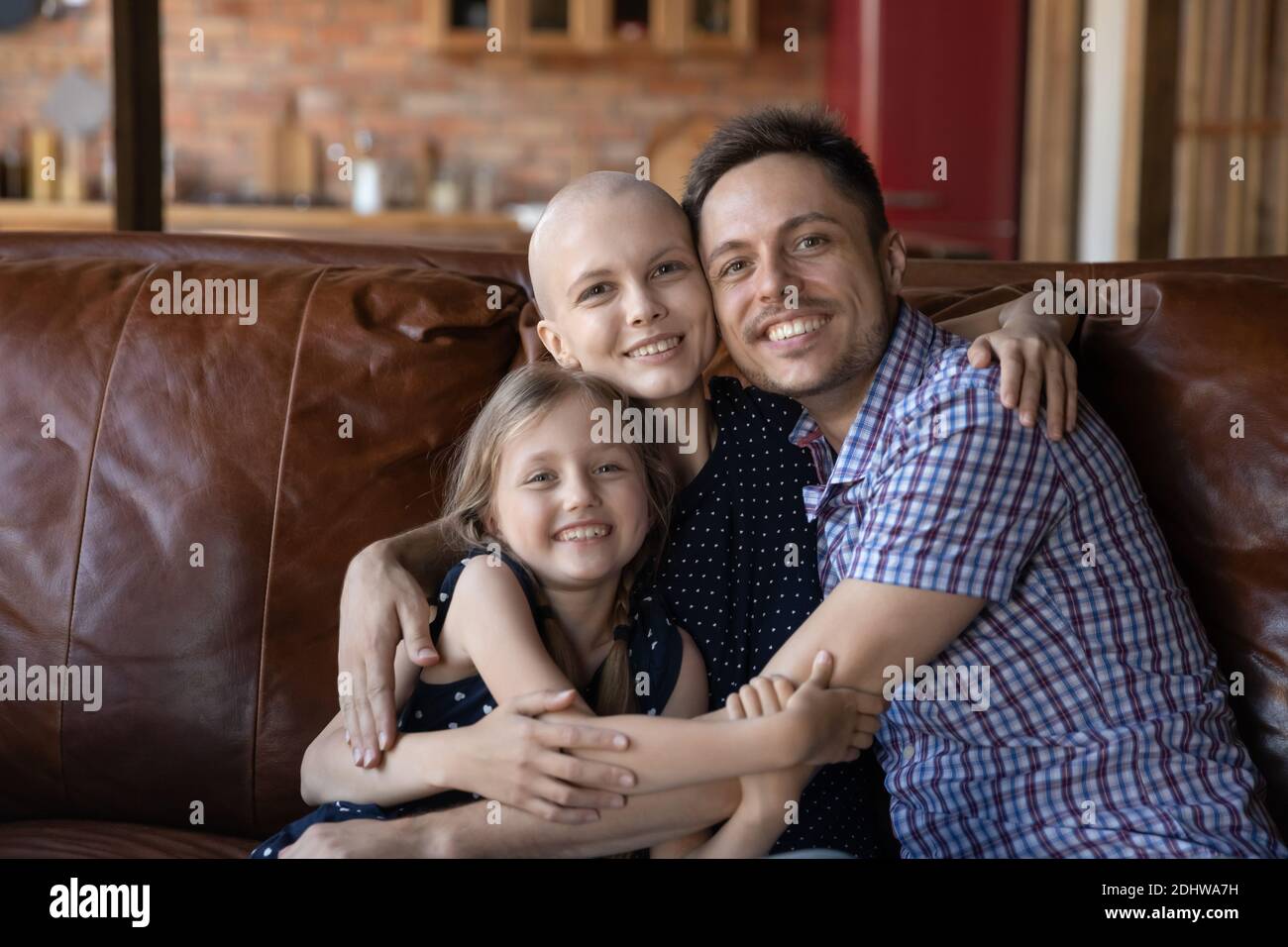 Portrait happy sick mother, father and little daughter cuddling Stock ...