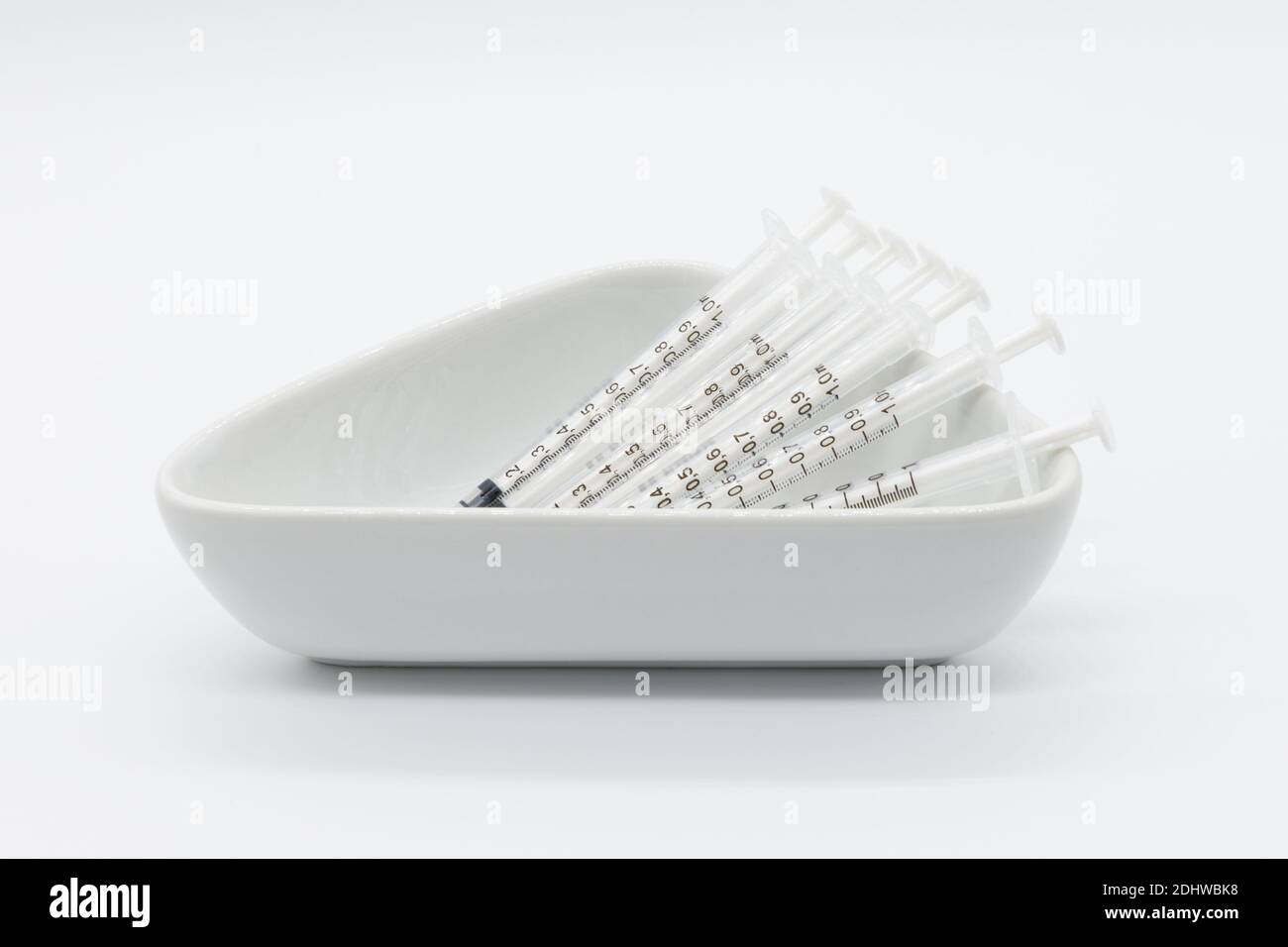 Six Medical vaccine syringes in a medical dish on a white background ...