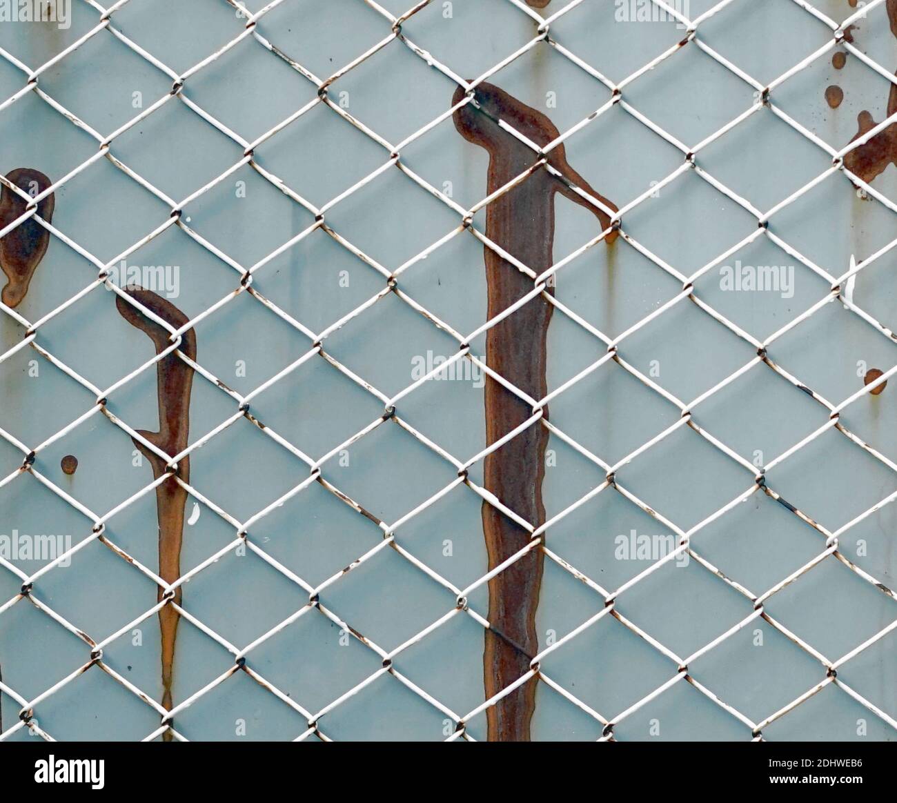 A texture and background of a vintage steel net fence on a rusty steel ...